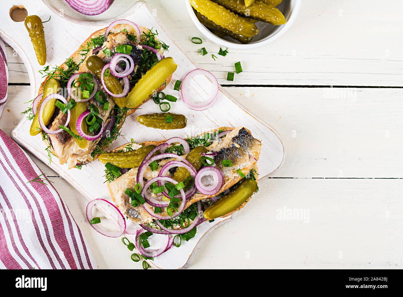 Traditional Dutch sandwich with herring and pickles cucumbers on white ...