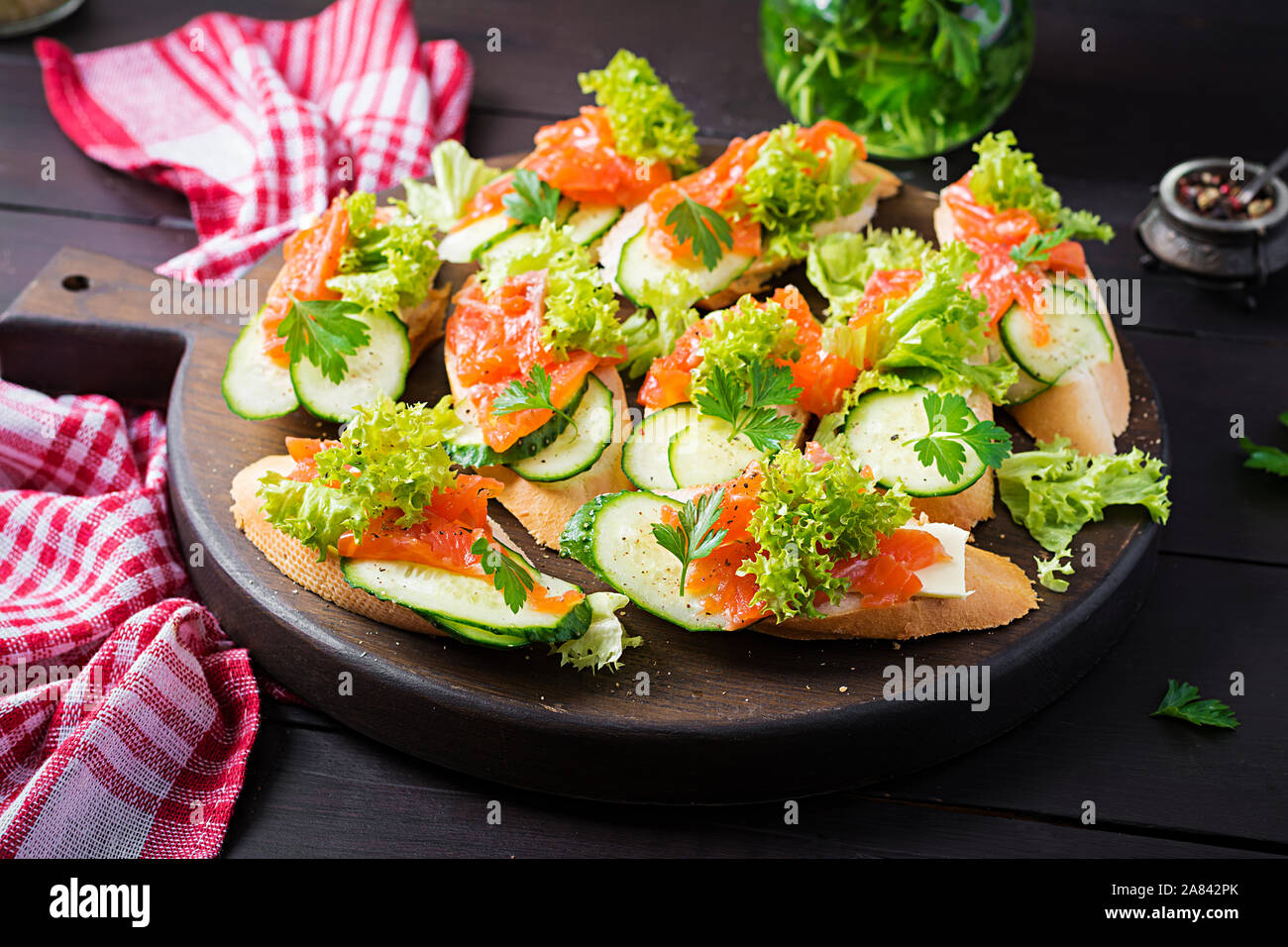Tapas. Salted Salmon, butter and cucumber toast sandwiches on wooden ...