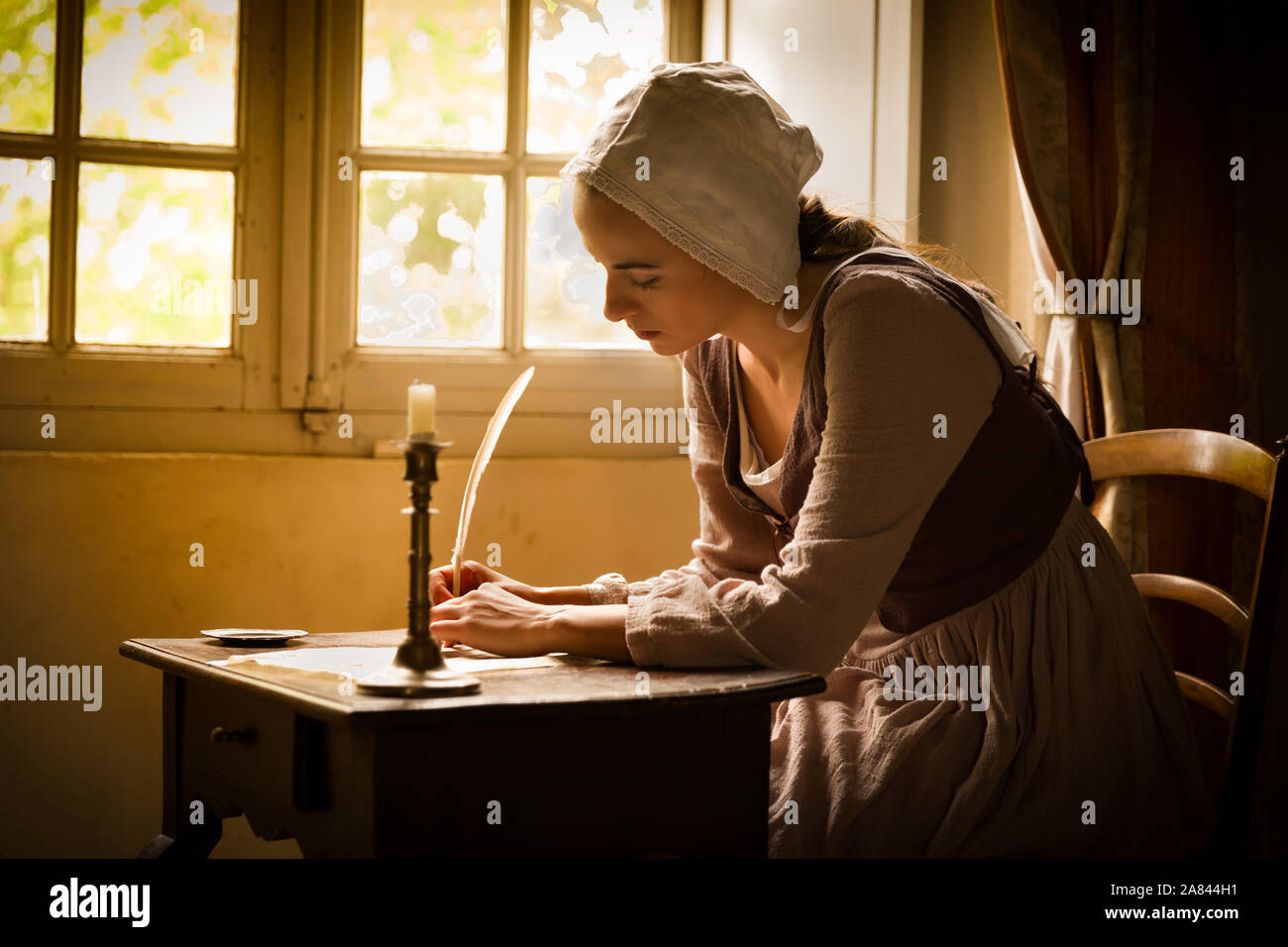 Vermeer style portrait of a young maid in renaissance costume writing a ...