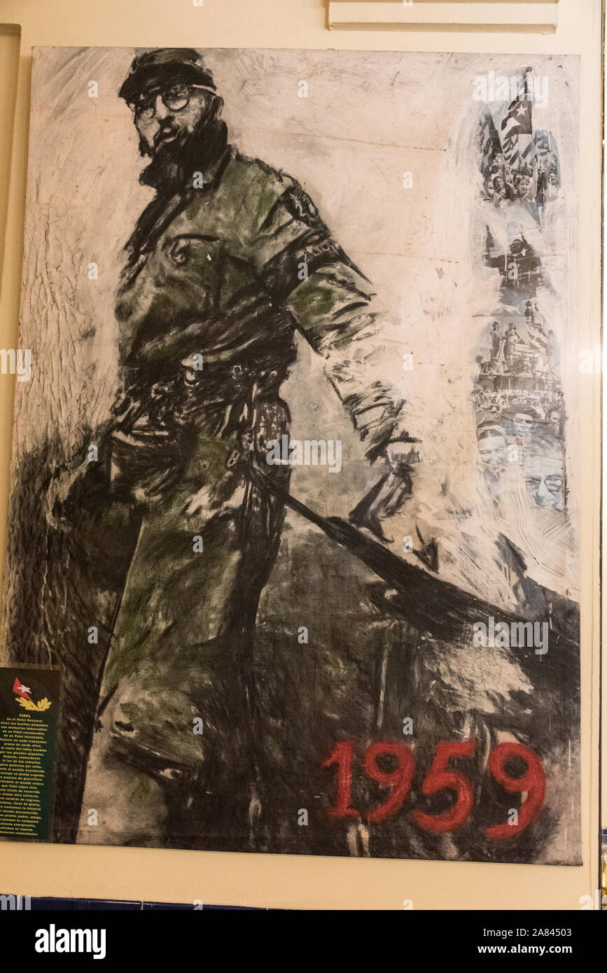 A large painting of Fidel Castro, former president of Cuba, hangs on ...
