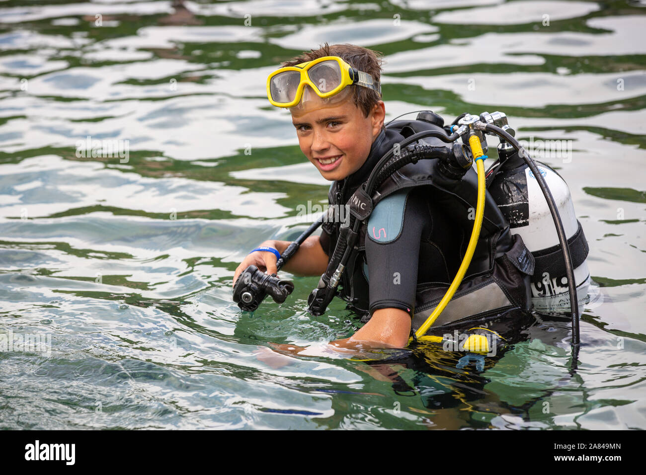 A young boy wearing full scuba diving outfit in the water Stock Photo ...