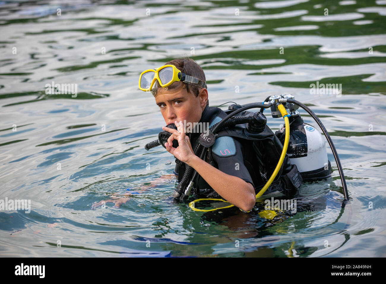 A young boy wearing full scuba diving outfit in the water Stock Photo ...