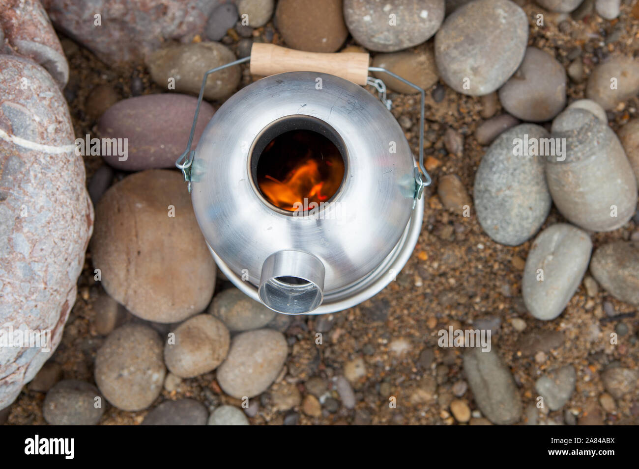 A kelly kettle being used at the beach Stock Photo - Alamy