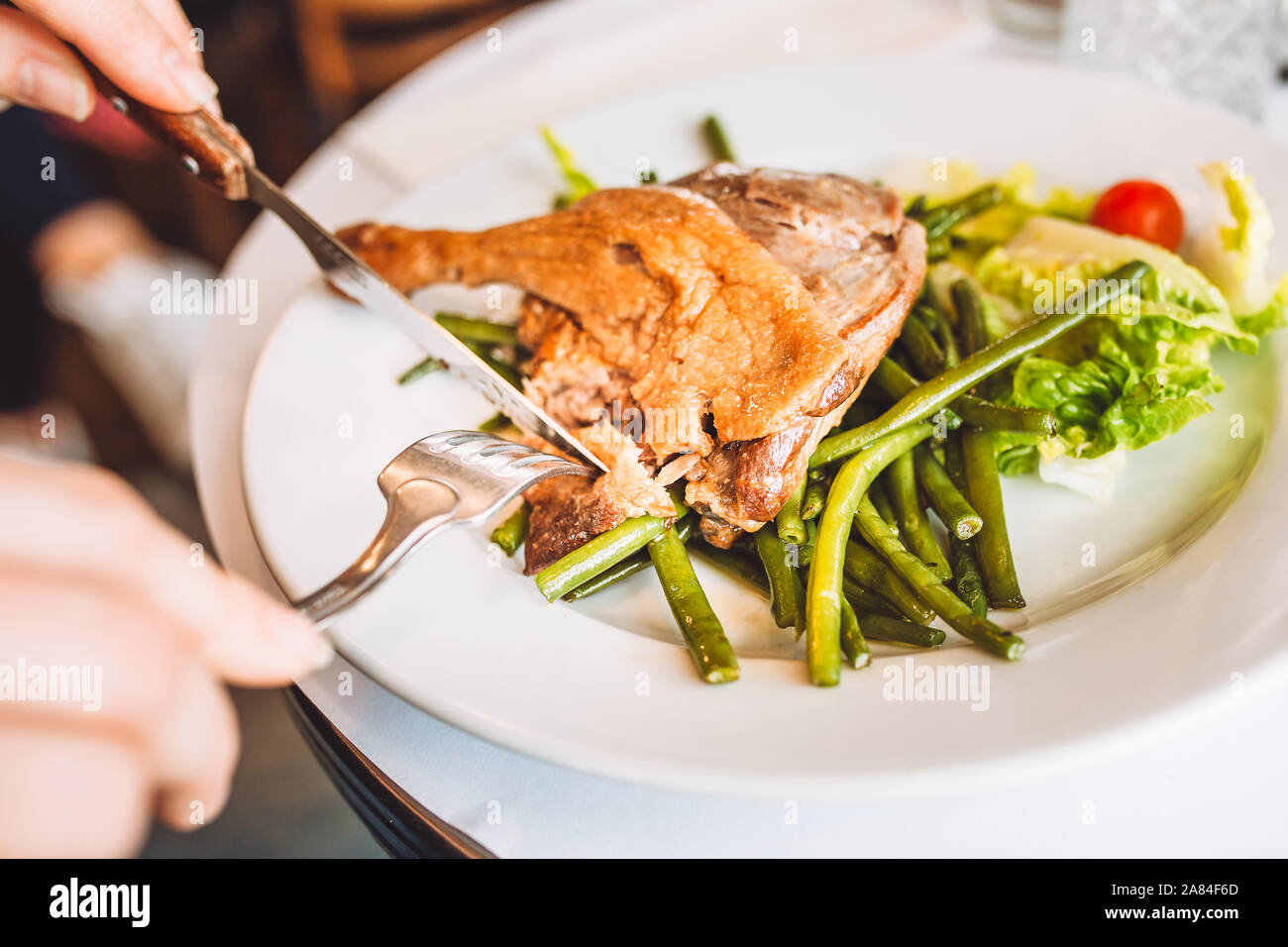 Lunch break - poultry dish - duck leg with asparagus garnish Stock ...