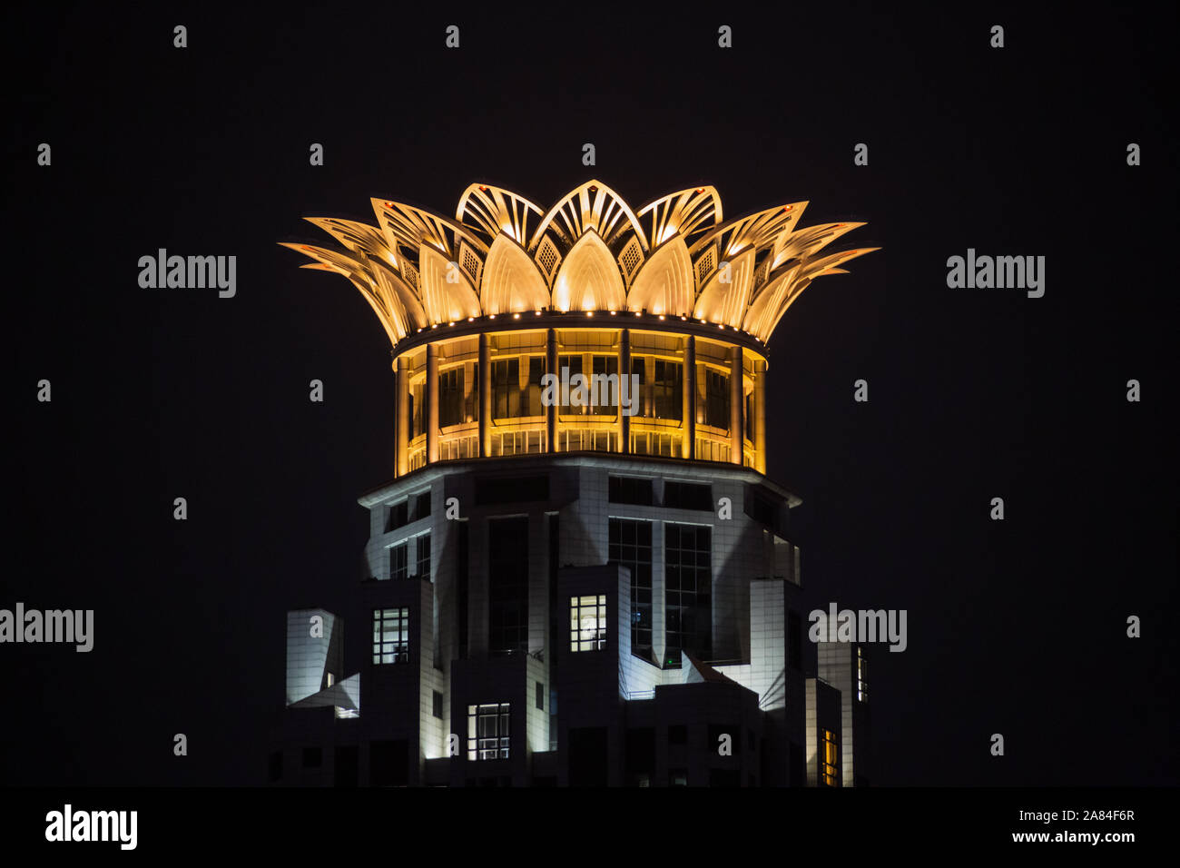Illuminated lotus crown on top of the Bund Center at night in Shanghai ...