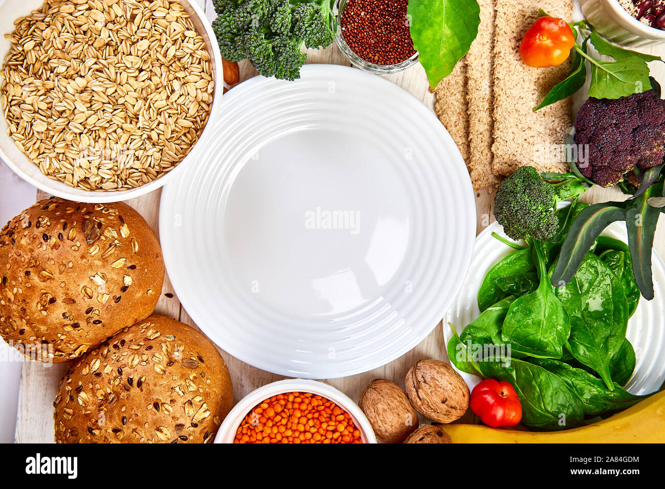 Selection food rich in fiber on white wooden background around empty ...