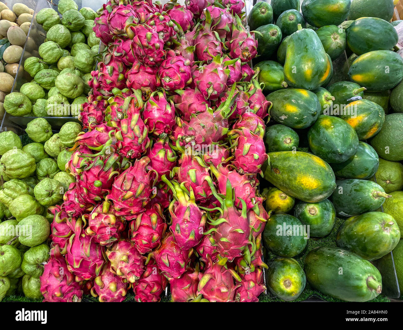 Dragon fruit, papaya and guava piled in tropical fruit store Stock ...