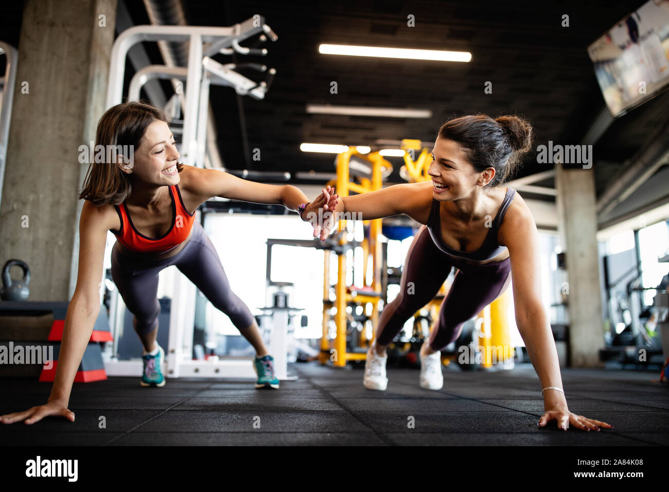 Attractive sports people are working out in gym Stock Photo - Alamy