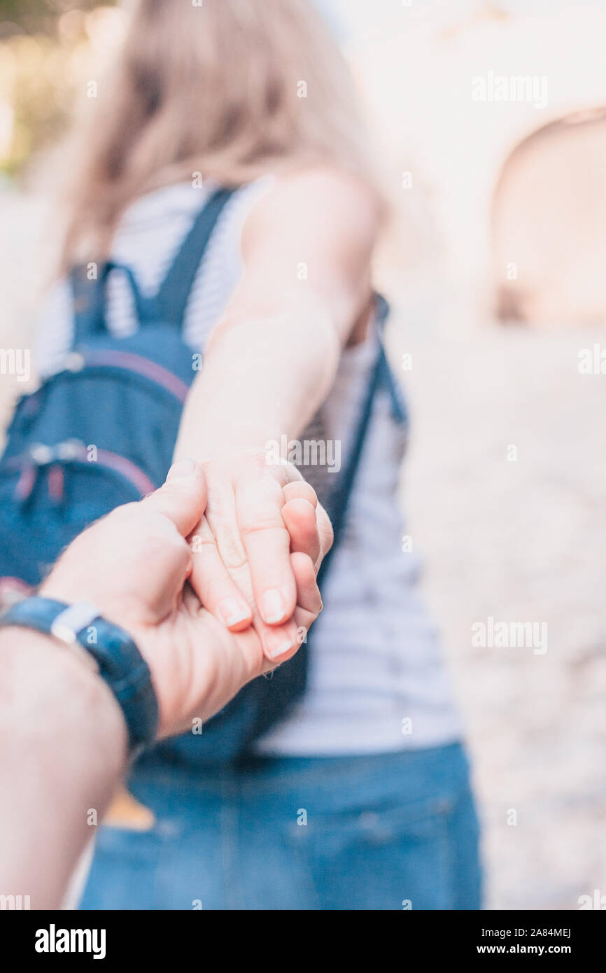 Picture in style follow me - a woman pulls the hand of a man - a first ...