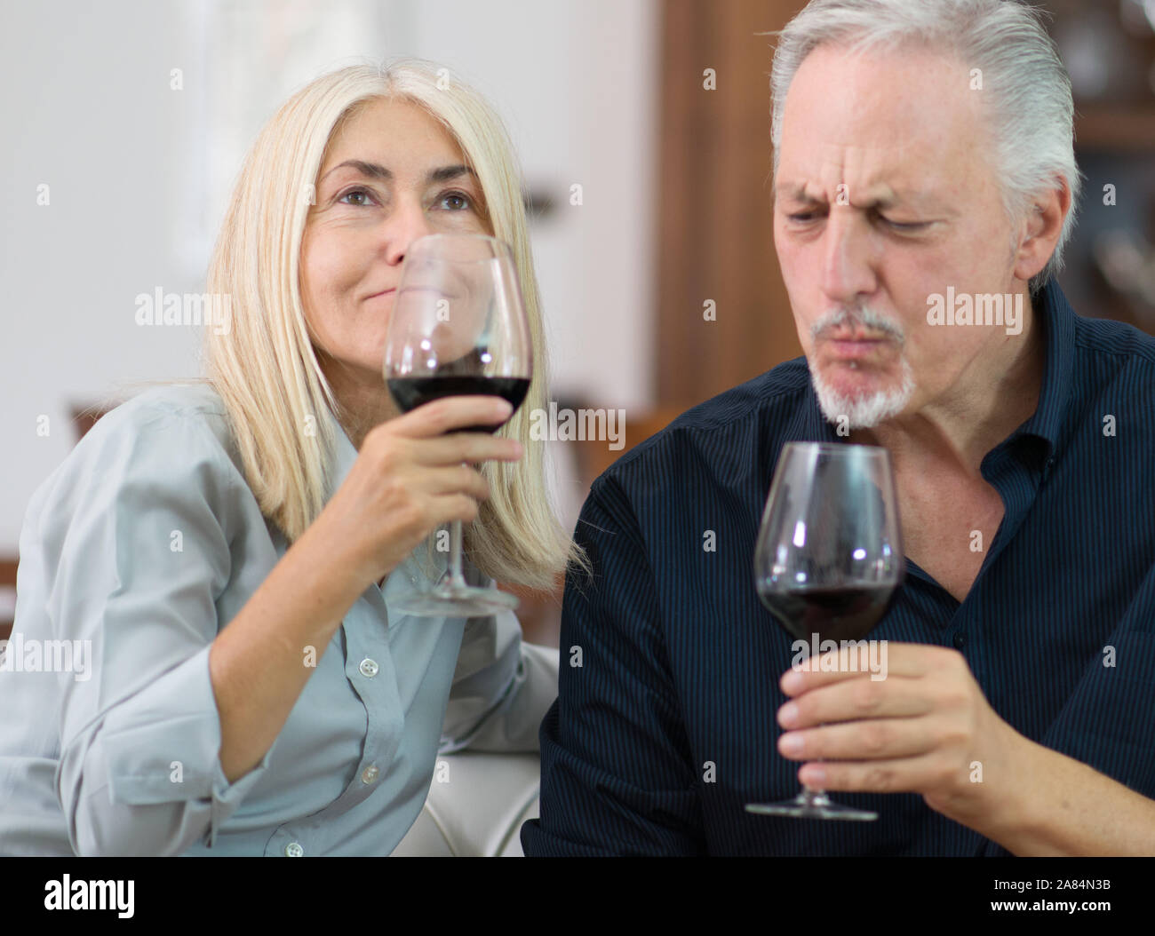 Couple drinking bad wine Stock Photo - Alamy