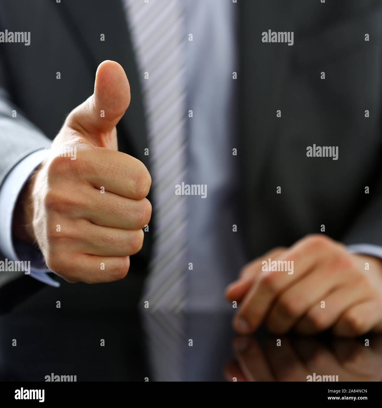 Male hand showing OK or confirm sign with thumb Stock Photo - Alamy
