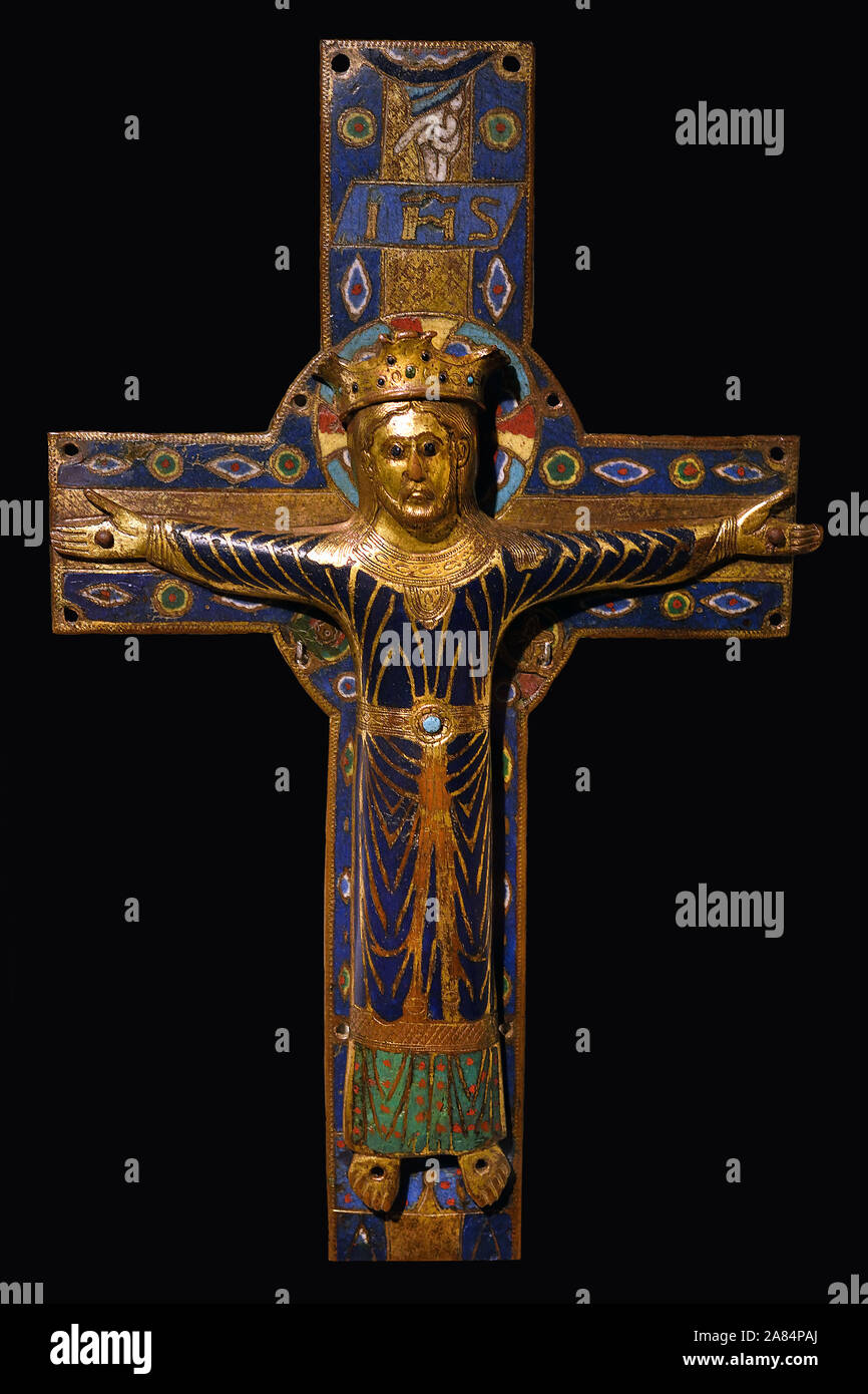 A copper crucifix, partially gilded and enamelled, Early 13th century ...