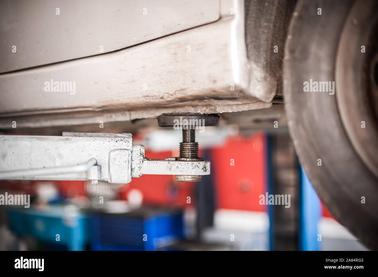Motor vehicle on lift in auto vulcanizing and service workshop. Close ...