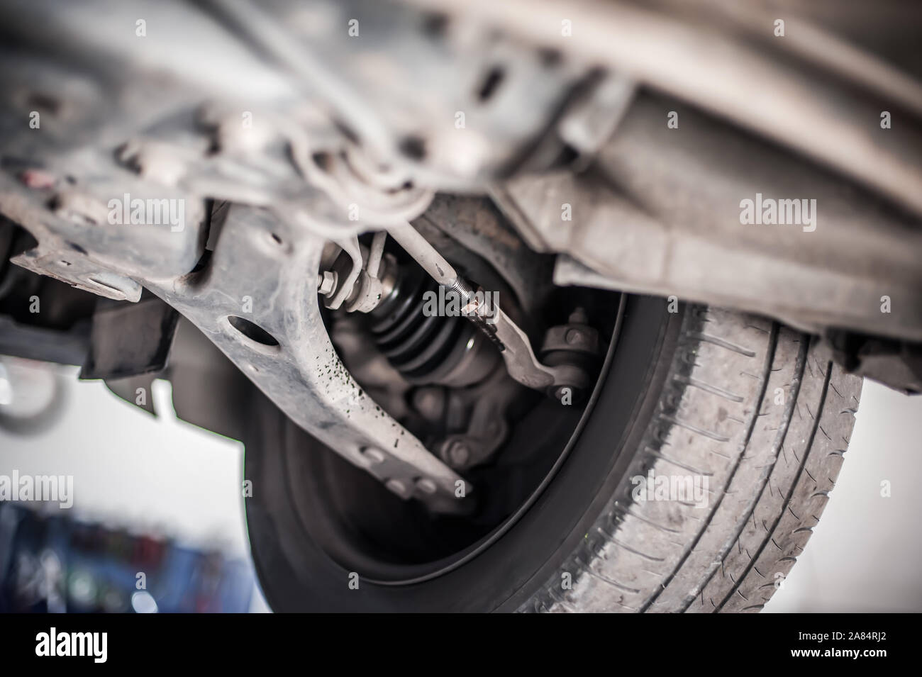 Motor vehicle on lift in auto vulcanizing and service workshop. Close ...