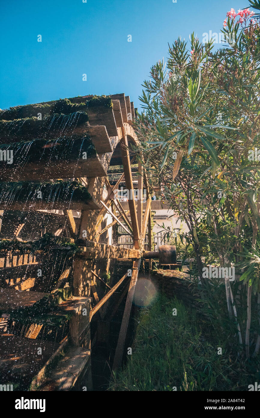 Old wooden water wheel runs on a fast mountain river Stock Photo - Alamy
