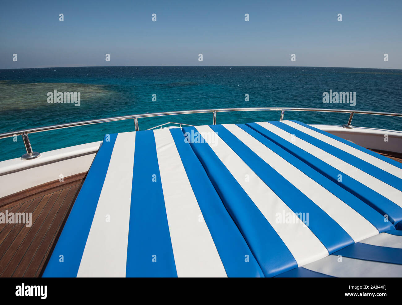 View over the bow of a large luxury motor yacht on tropical open ocean ...