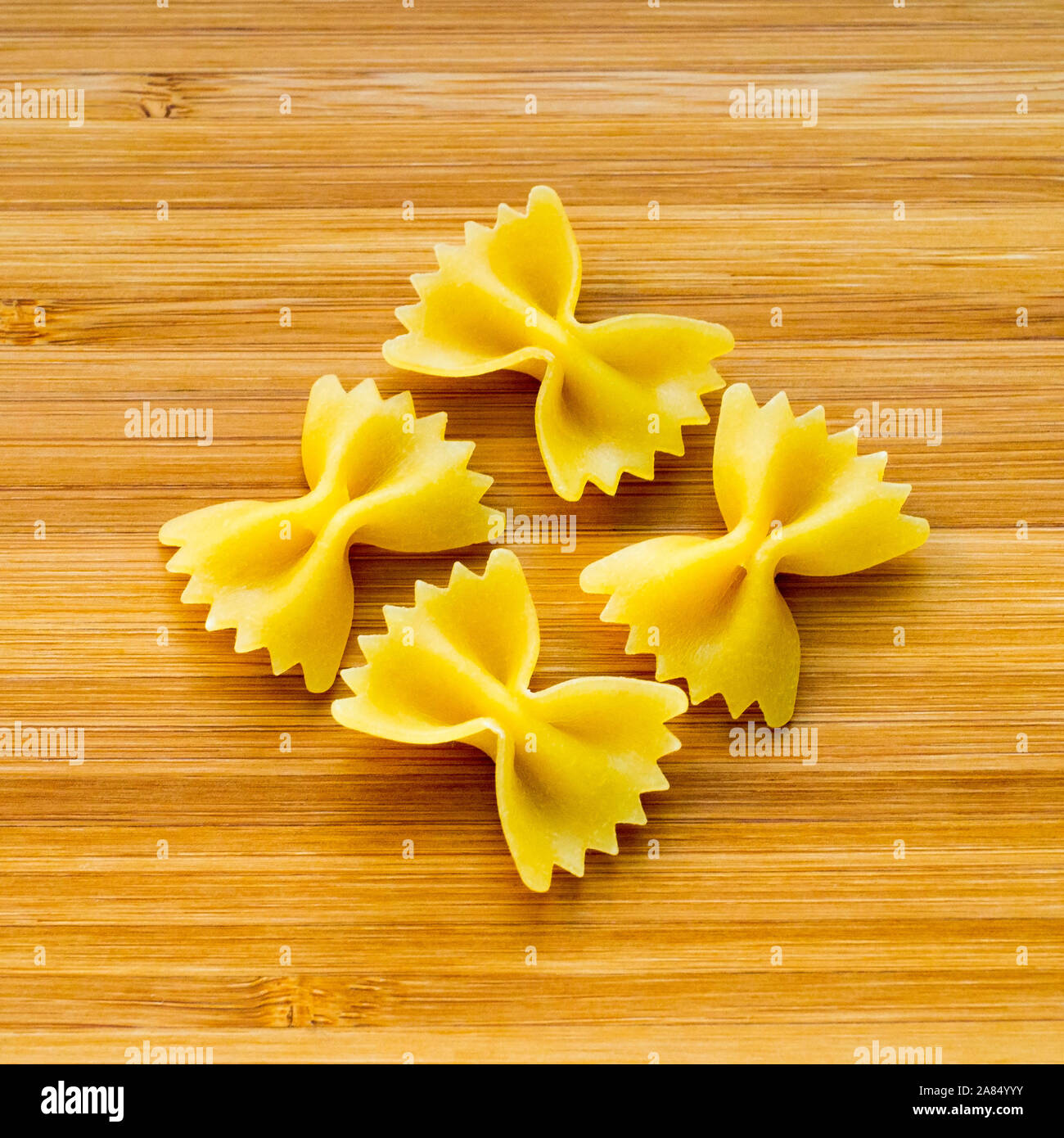 Four butterflies for italian pasta on wood background. Dietary food of ...