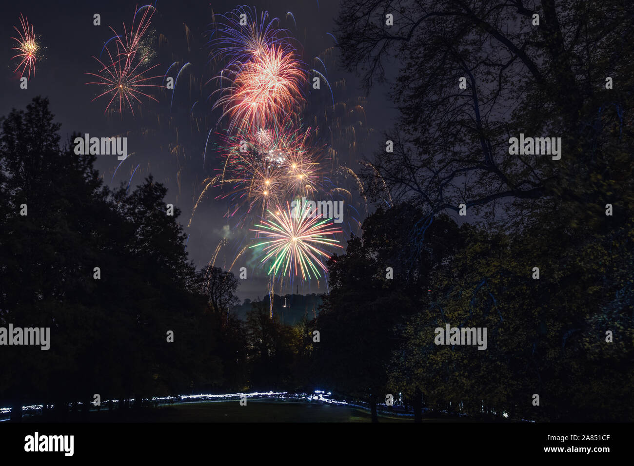 Light trails of people holding their phones and walking towards a ...