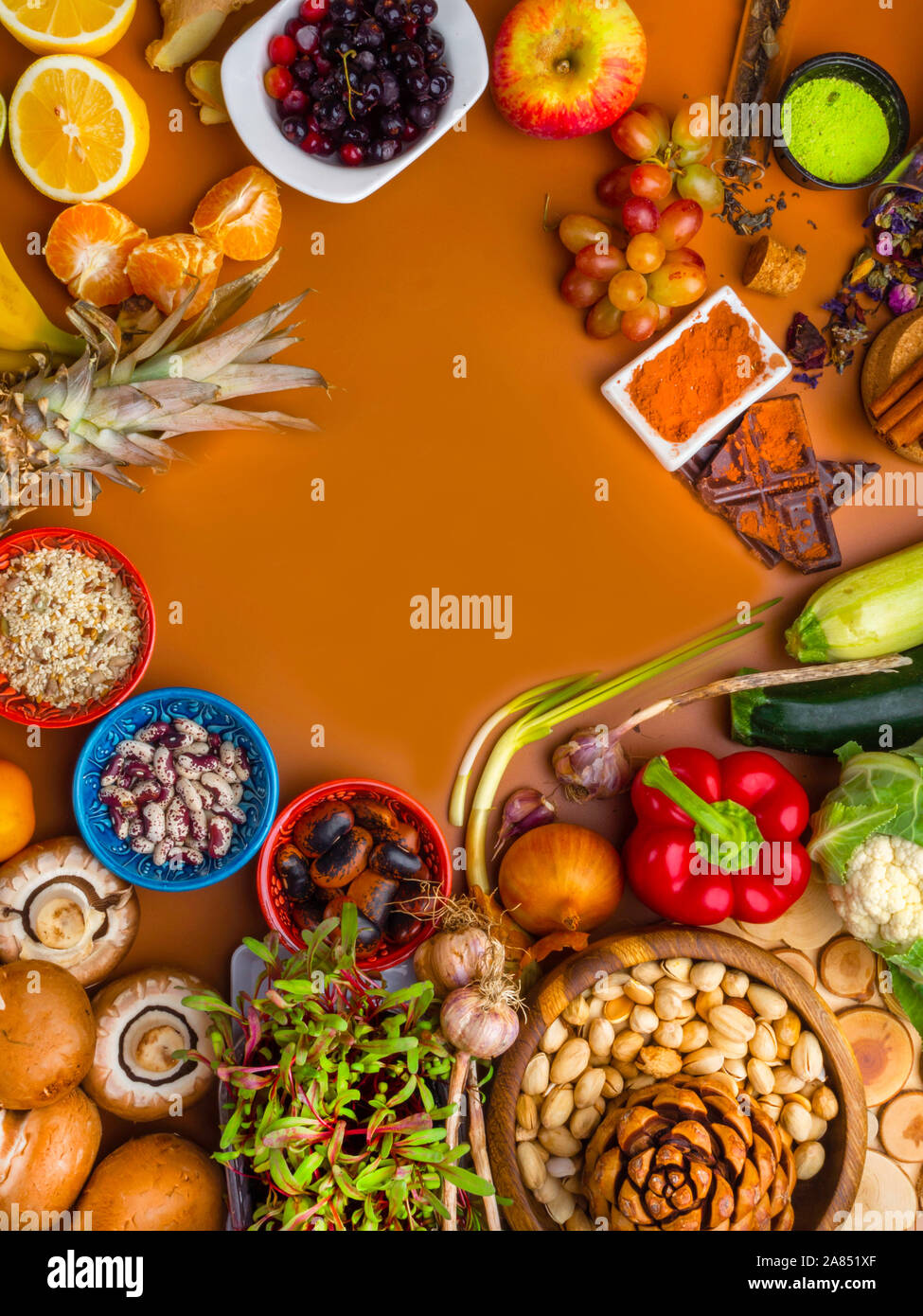 Mixed colorful foods as nuts, fruits, vegetables, beans, herbs, powders ...