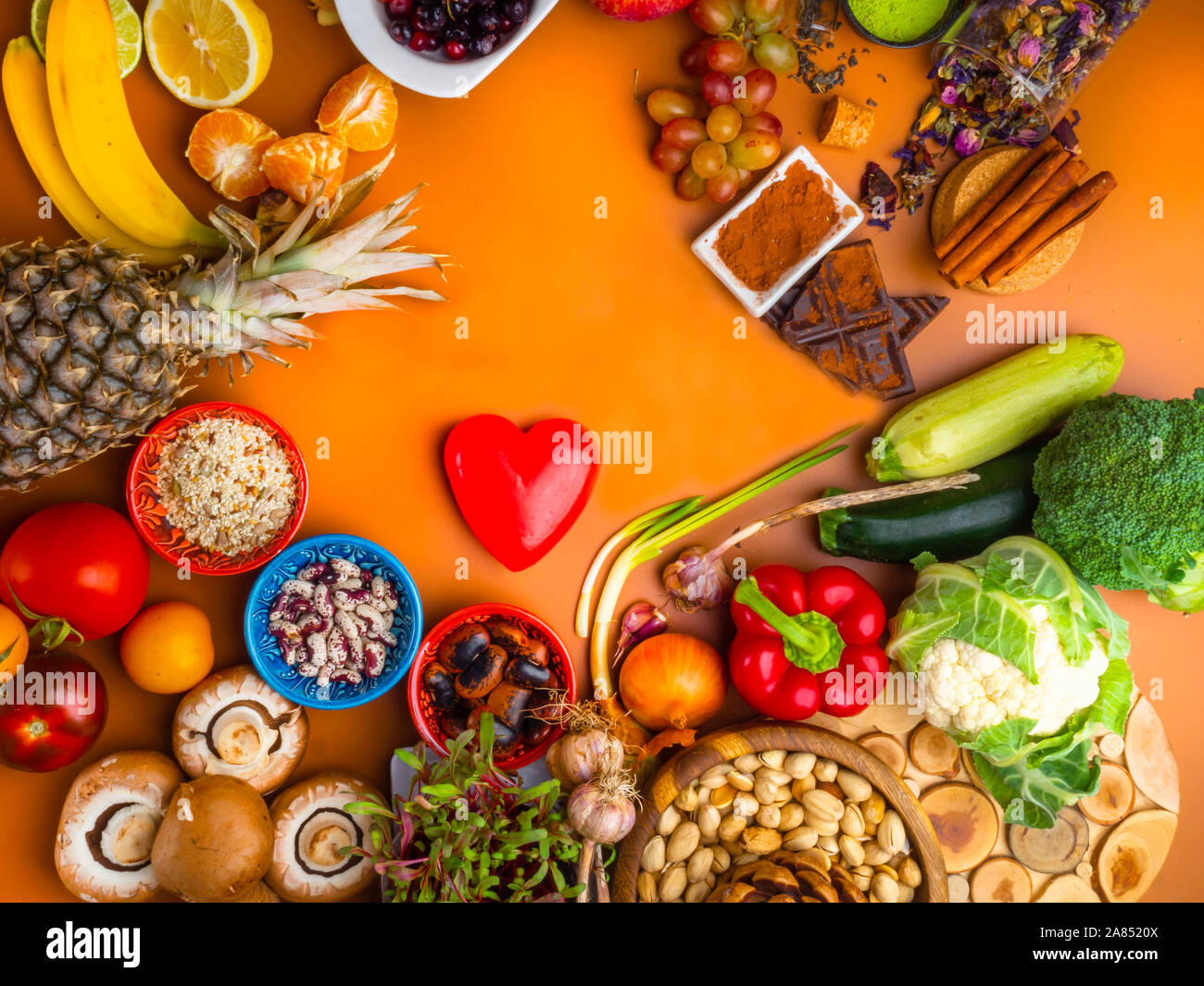 Mixed colorful foods as nuts, fruits, vegetables, beans, herbs, powders ...