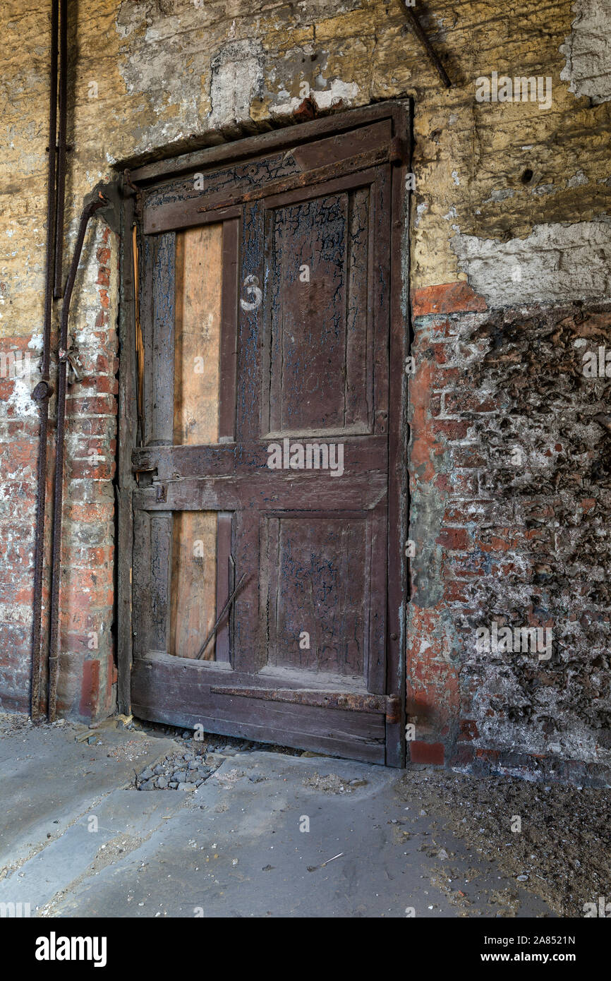 broken door in an abandoned mill building Stock Photo - Alamy