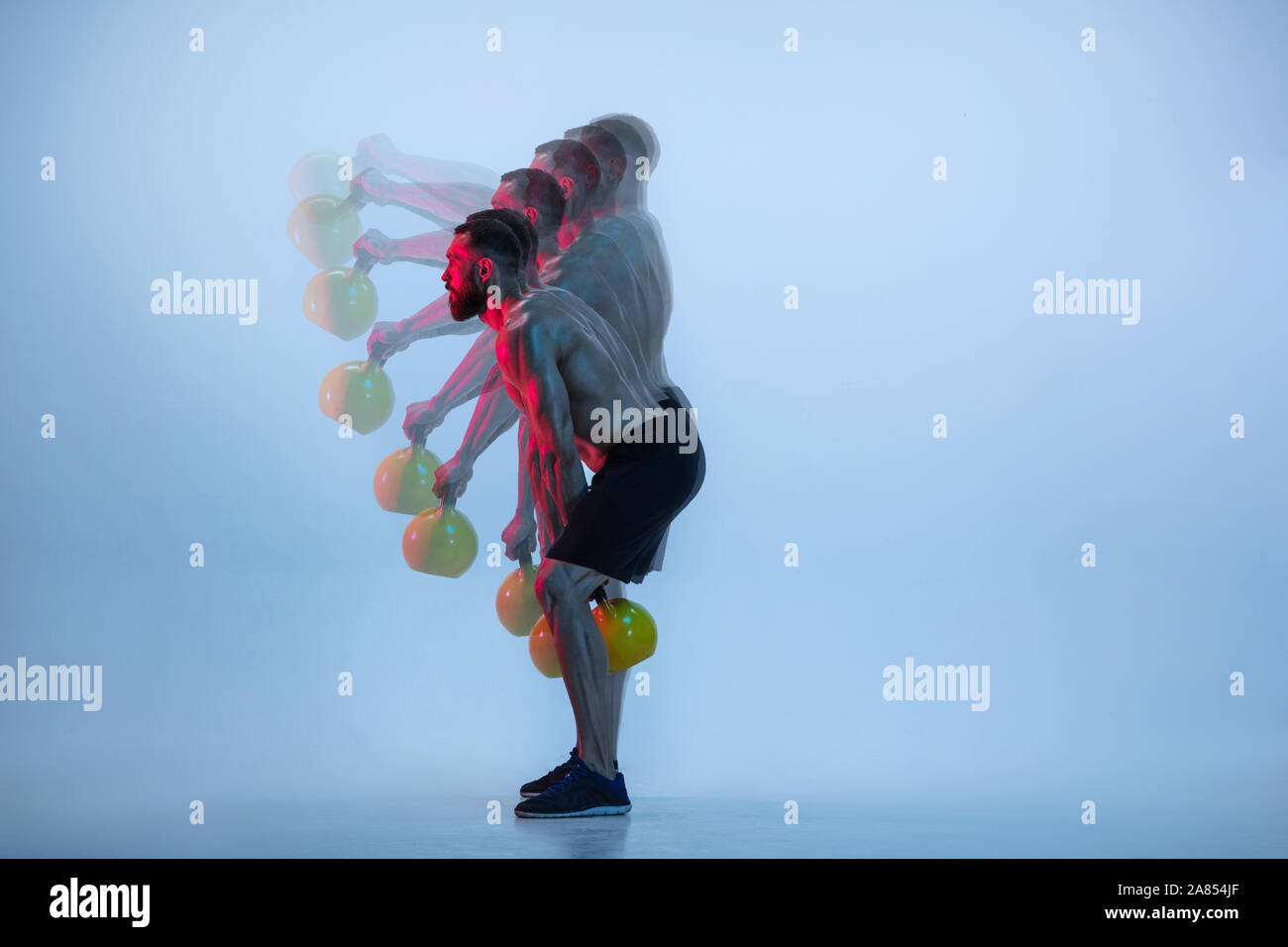 Dream. Young caucasian bodybuilder training over studio background in ...