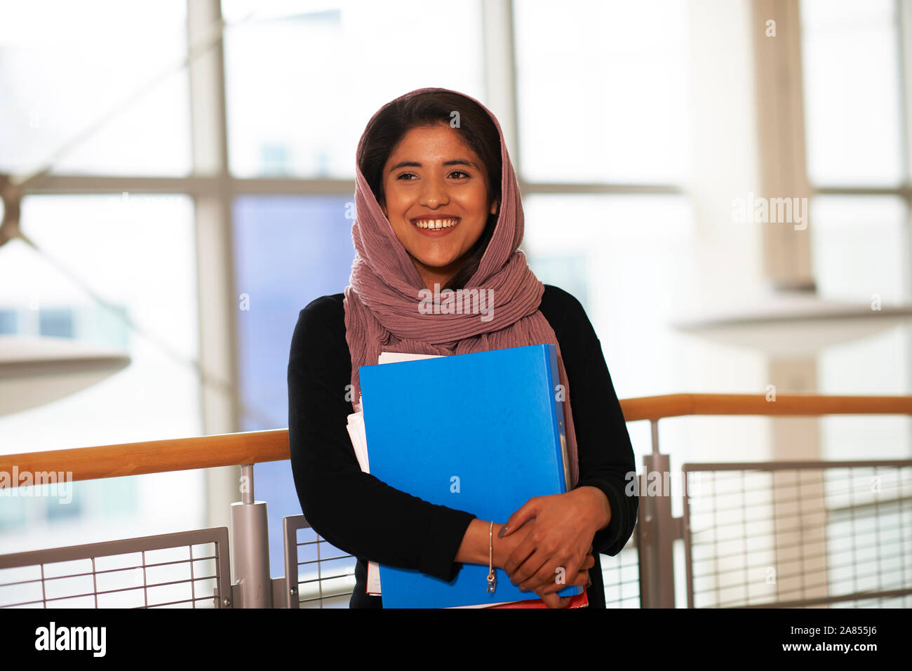 Portrait smiling, confident young female college student wearing hijab ...