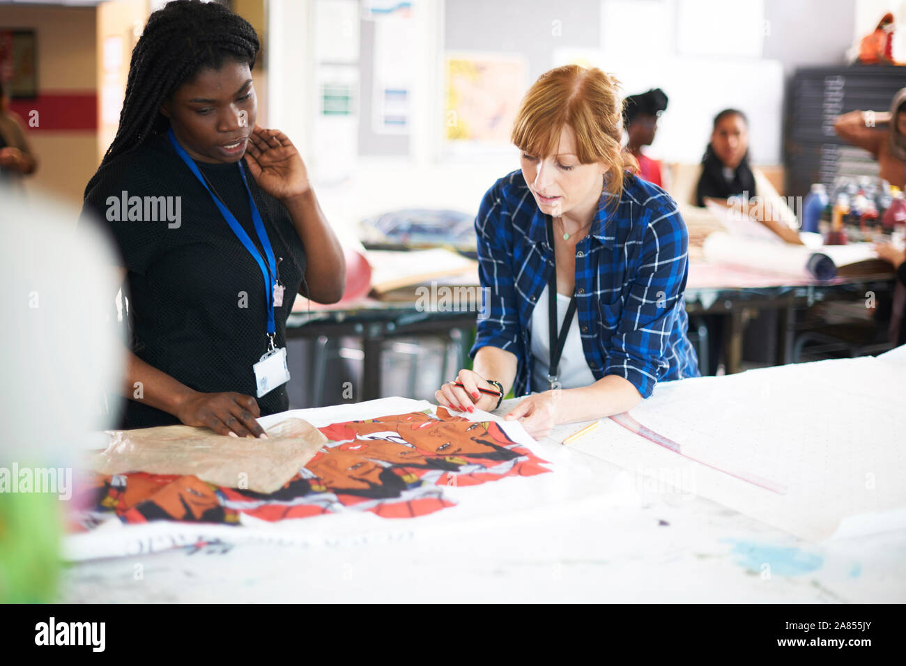 Female artists looking at screen print in art studio Stock Photo - Alamy