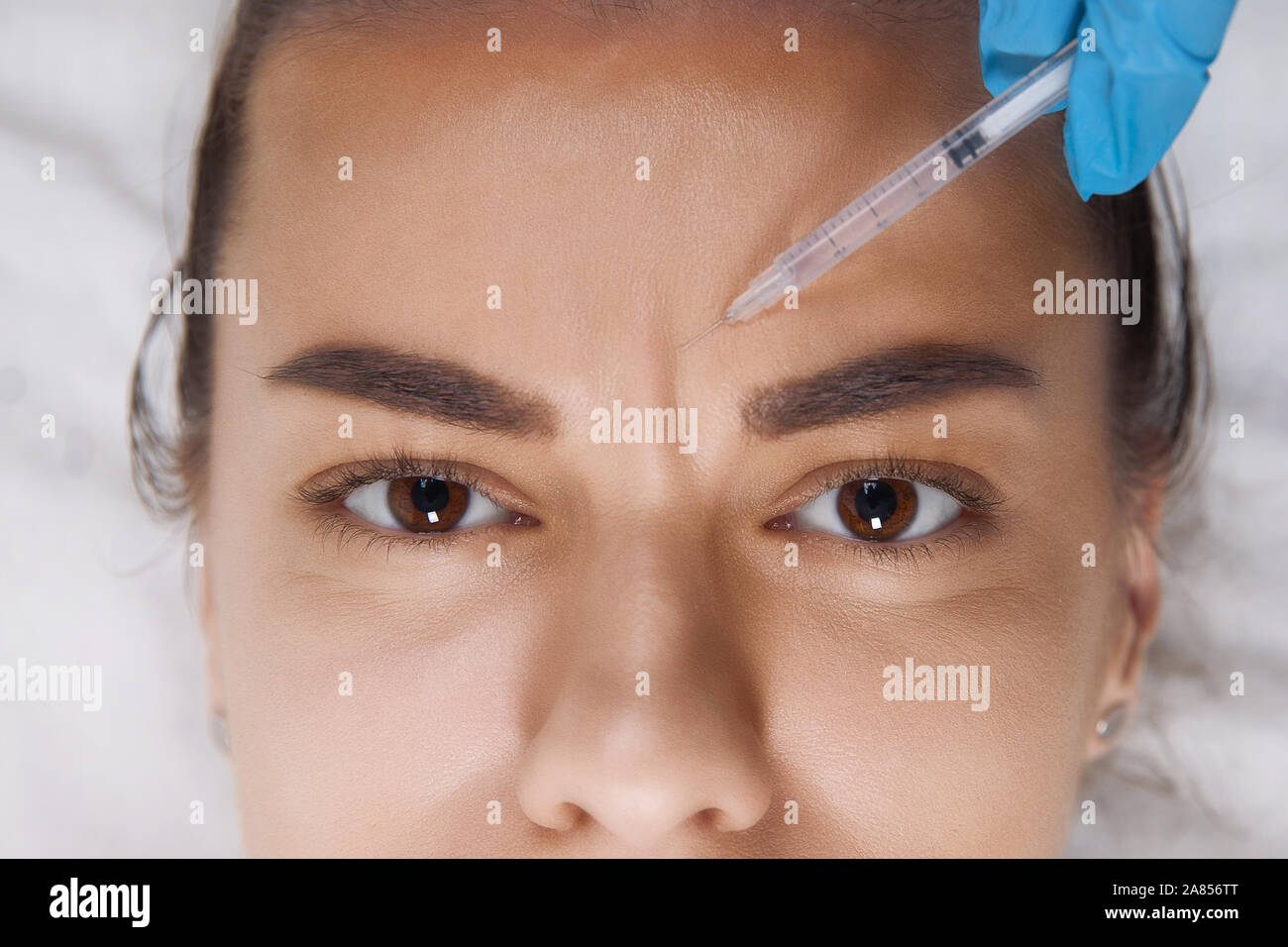 Closeup Portrait of young Caucasian woman getting cosmetic injection in ...