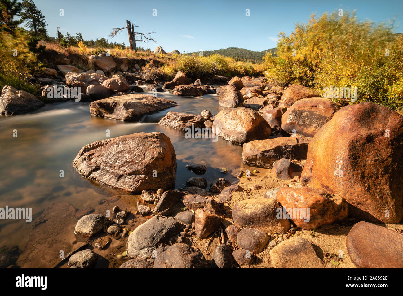 Mountain stream flowing over large boulders Stock Photo - Alamy