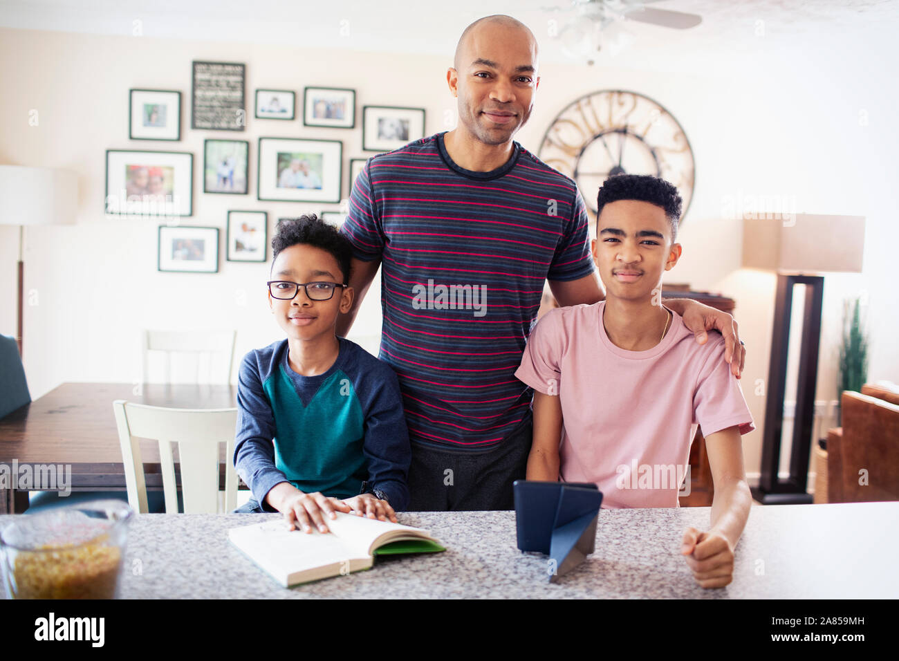 Portrait confident father and sons in kitchen Stock Photo - Alamy
