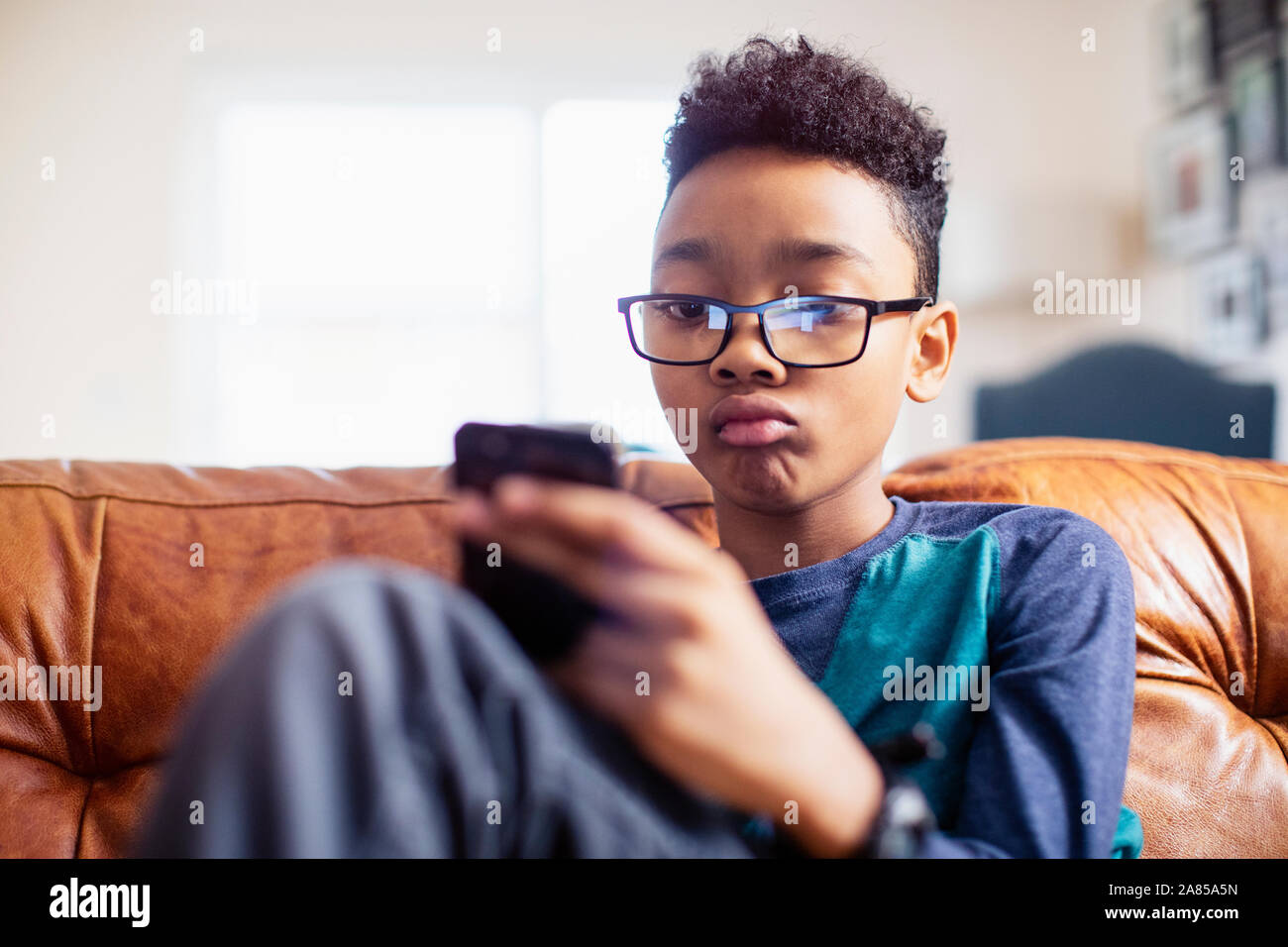Boy using mobile device hi-res stock photography and images - Alamy