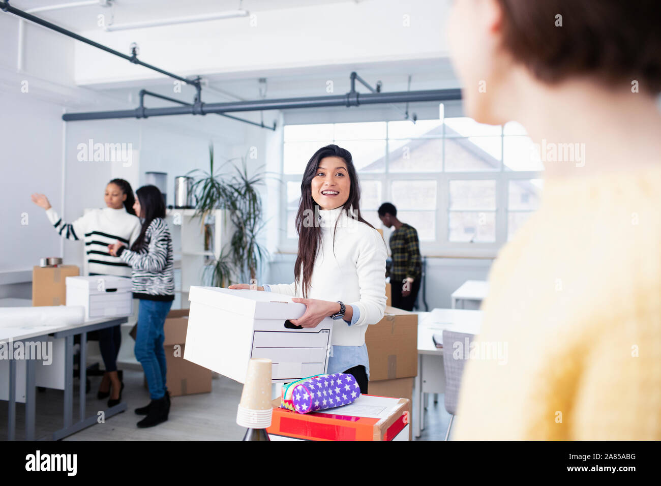 Businesswomen moving into new office Stock Photo - Alamy