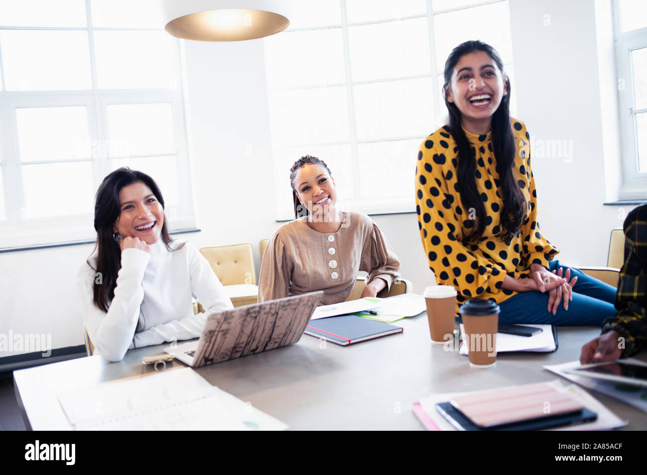 Businesswomen laughing in conference room meeting Stock Photo - Alamy