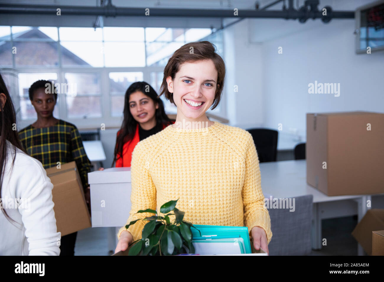 Portrait confident businesswoman moving into new office Stock Photo - Alamy