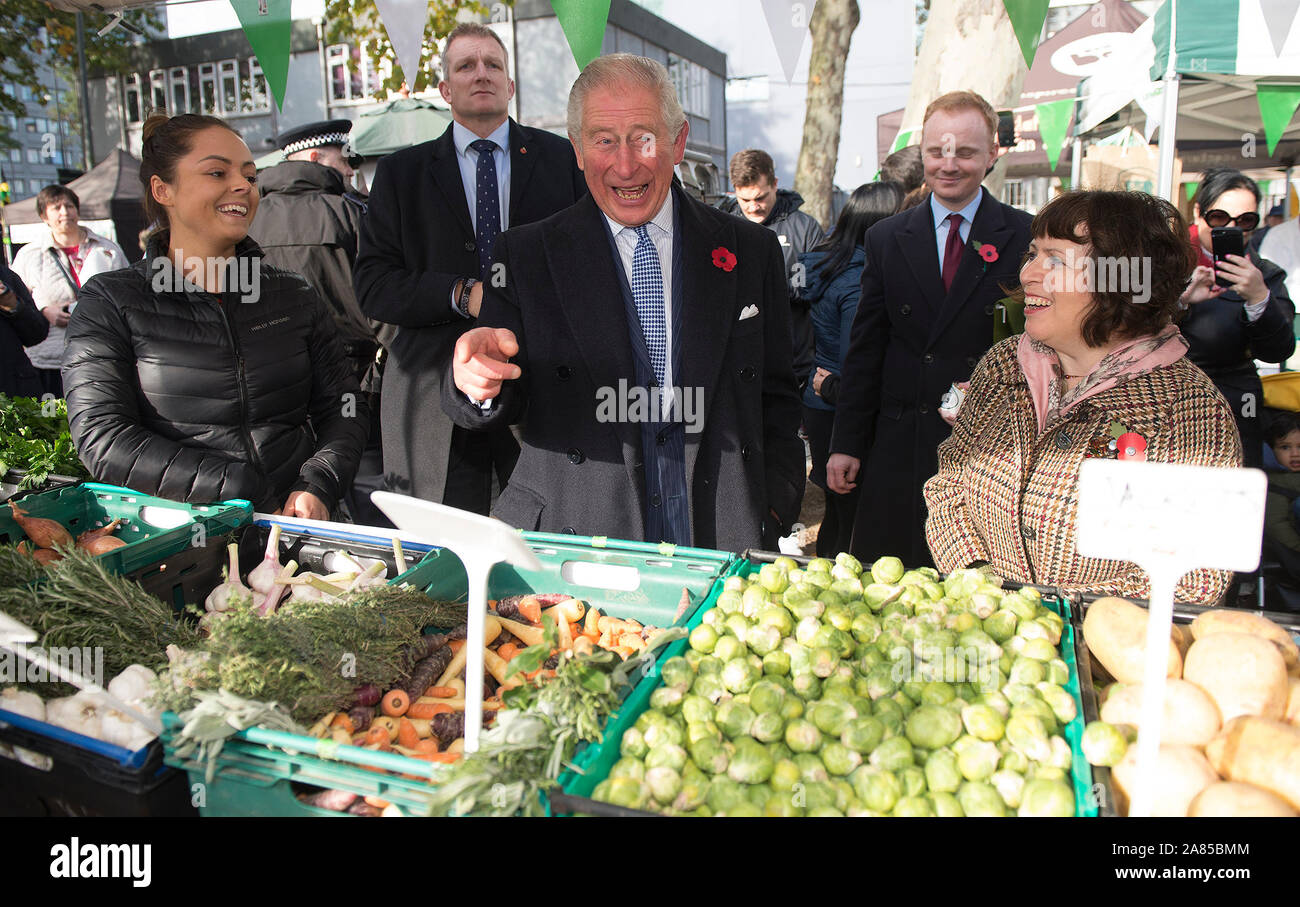 The Prince of Wales browses a fruit and vegetable stall during a visit ...