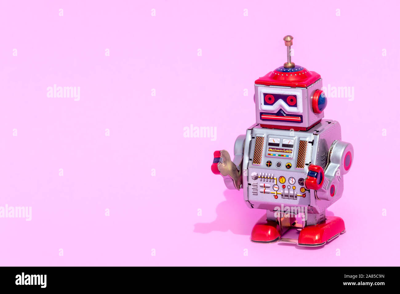 Antique tin toy robot on pink background. Vintage and classic concept ...