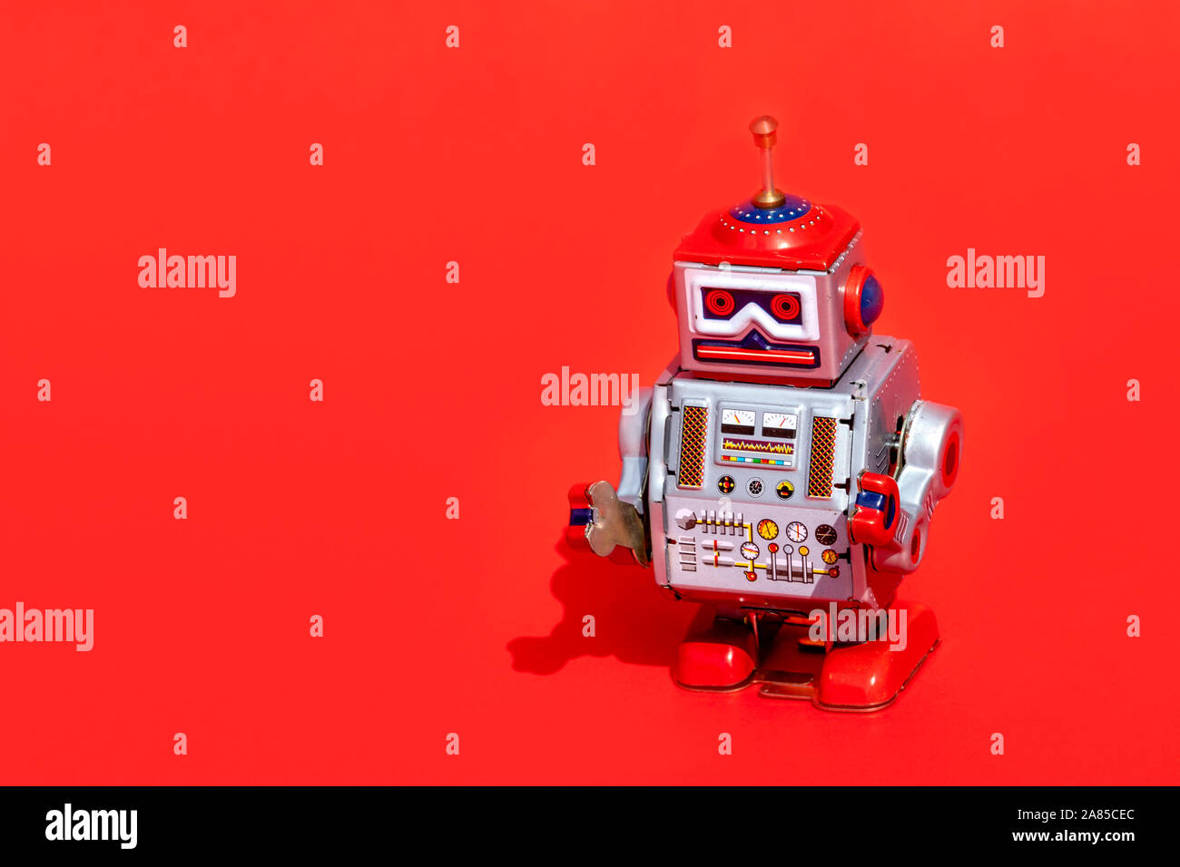 Antique tin toy robot on red background. Vintage and classic concept ...
