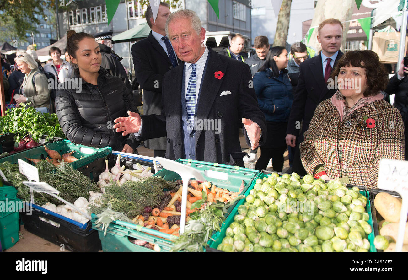 The Prince of Wales browses a fruit and vegetable stall during a visit ...