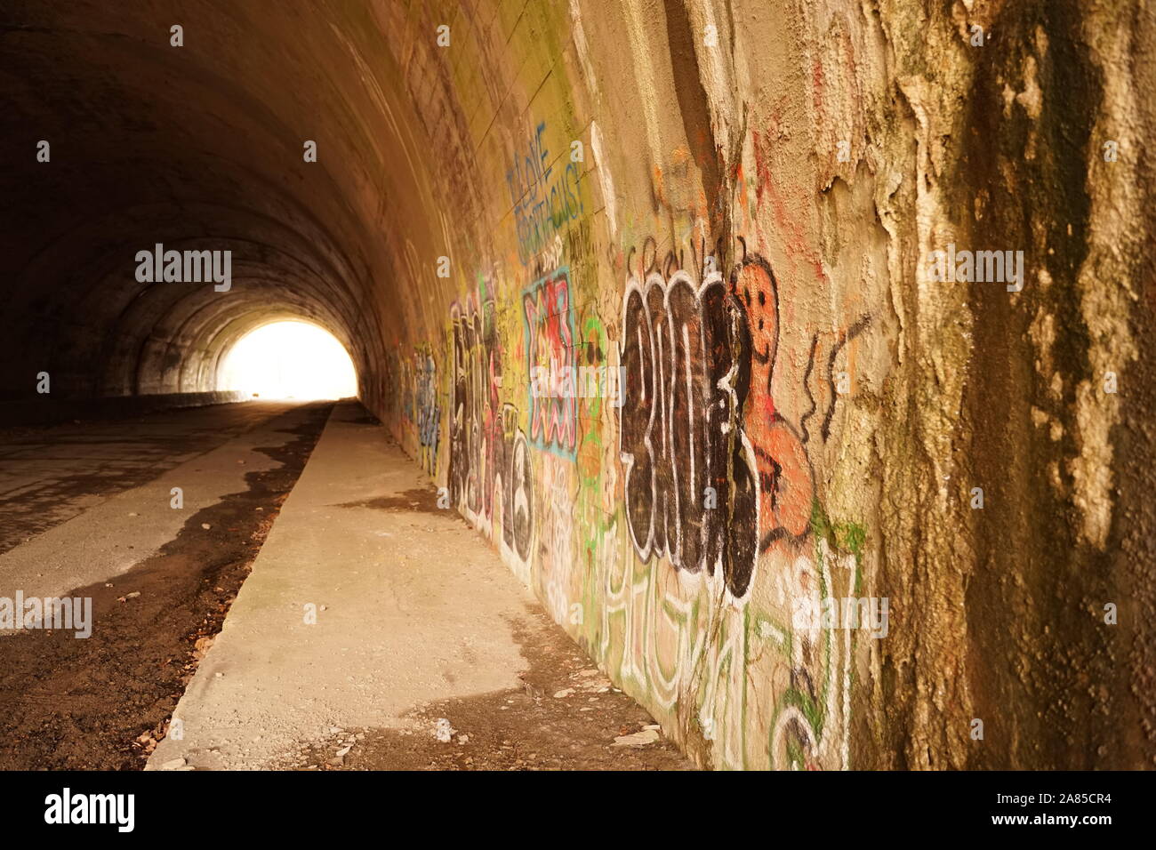 Abandoned graffiti tunnel with old mining stairs and conveyor system ...