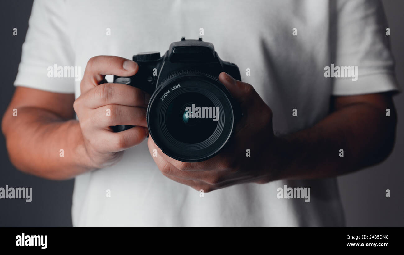 Photographer holding a digital camera Stock Photo - Alamy