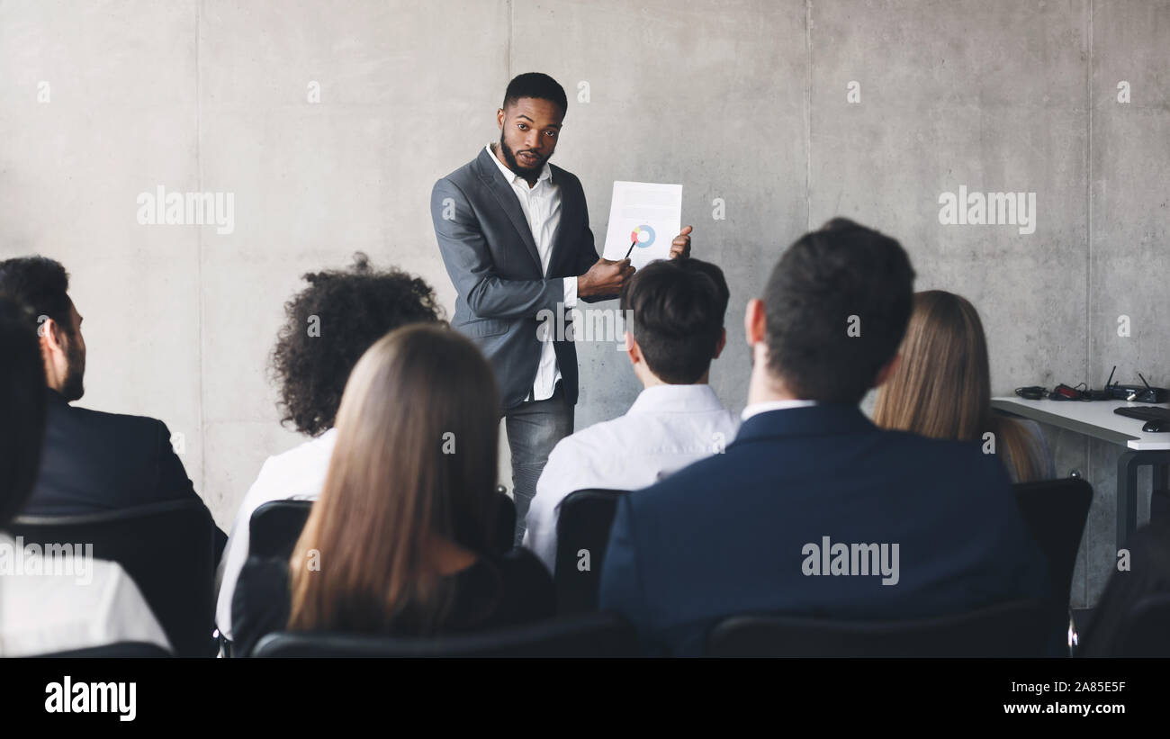 Top manager showing chart to colleagues, making presentation Stock ...
