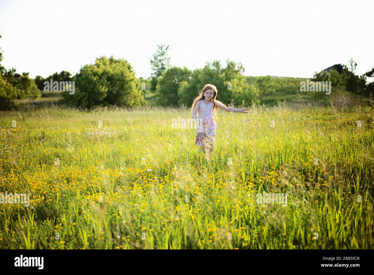 Happy girl skipping hi-res stock photography and images - Alamy