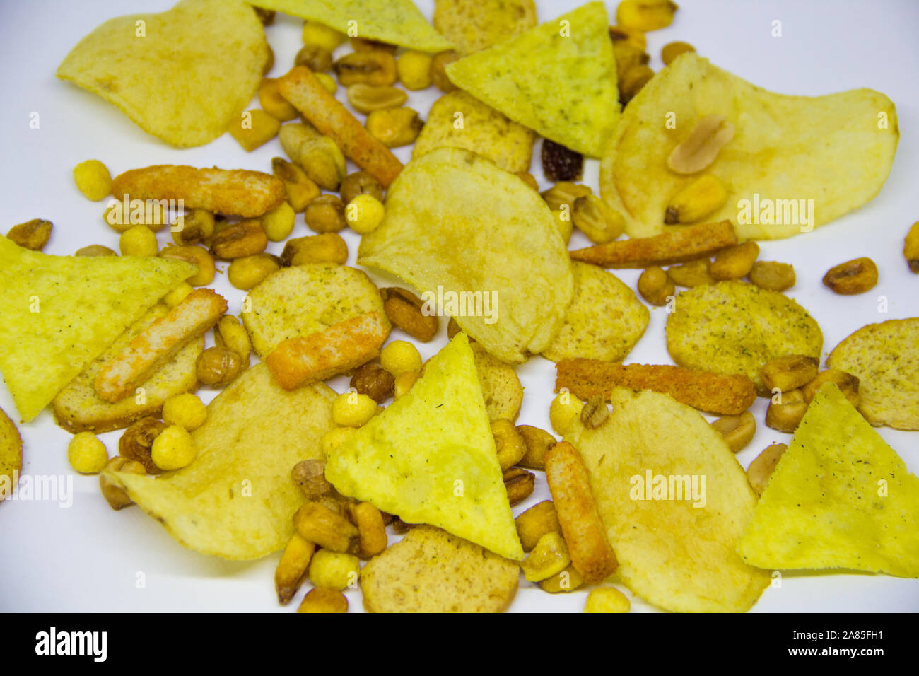 beer mix, crackers, chips, nuts, peanuts, salted corn on a white ...