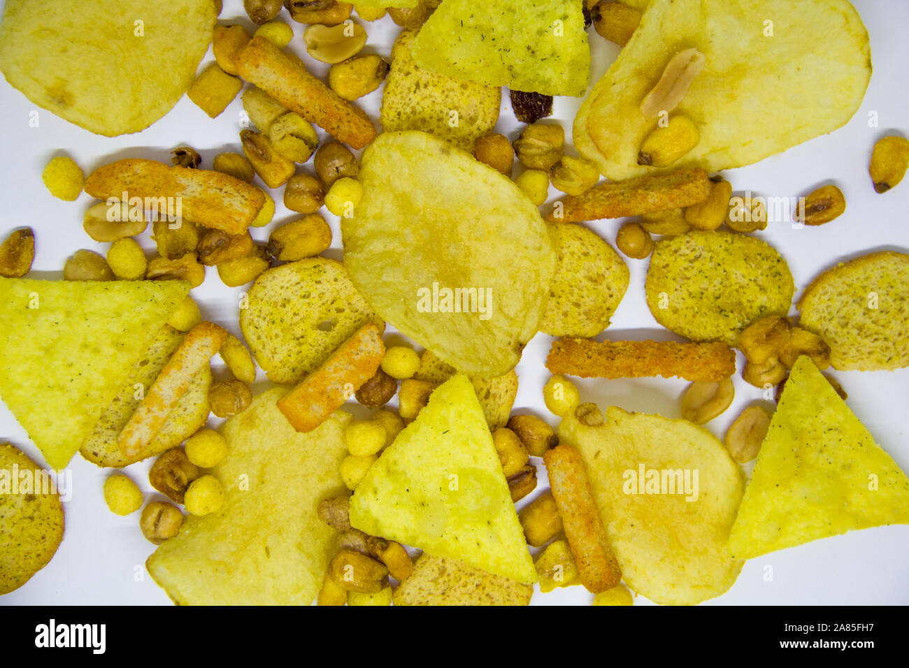 beer mix, crackers, chips, nuts, peanuts, salted corn on a white ...