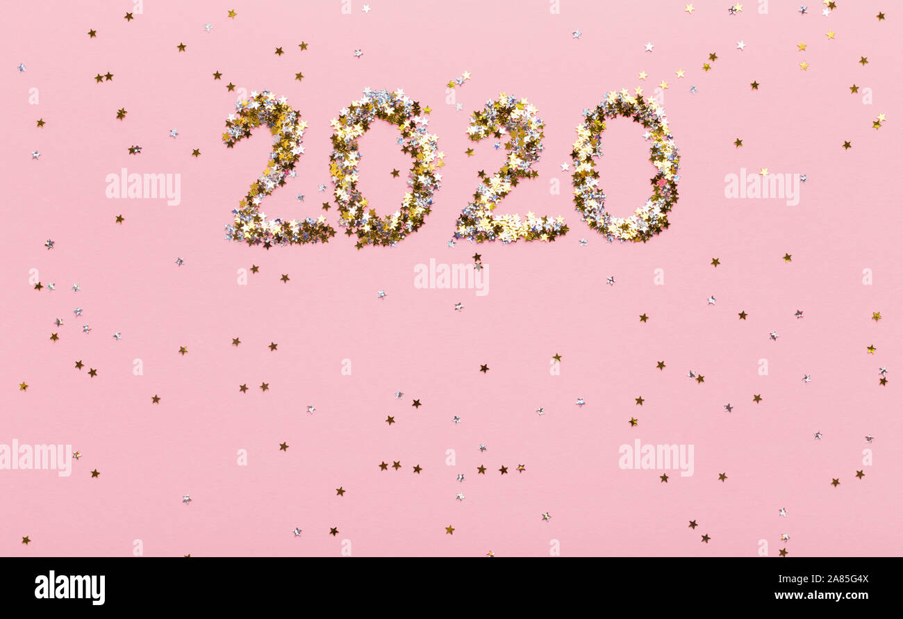 Super glowing background with gold 2020 of confetti on pink Stock Photo ...