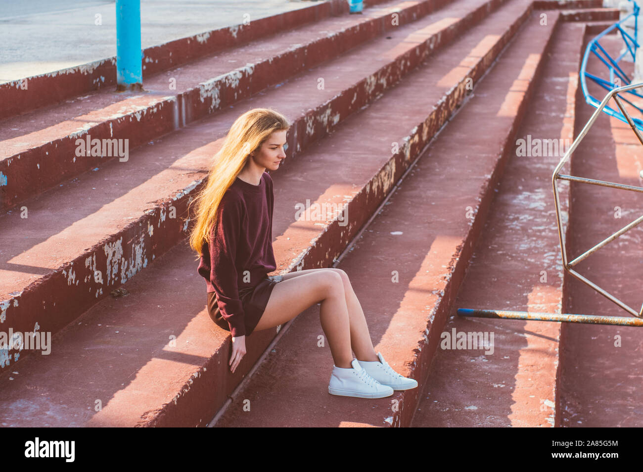 Woman sitting on stairs skirt hi-res stock photography and images - Alamy