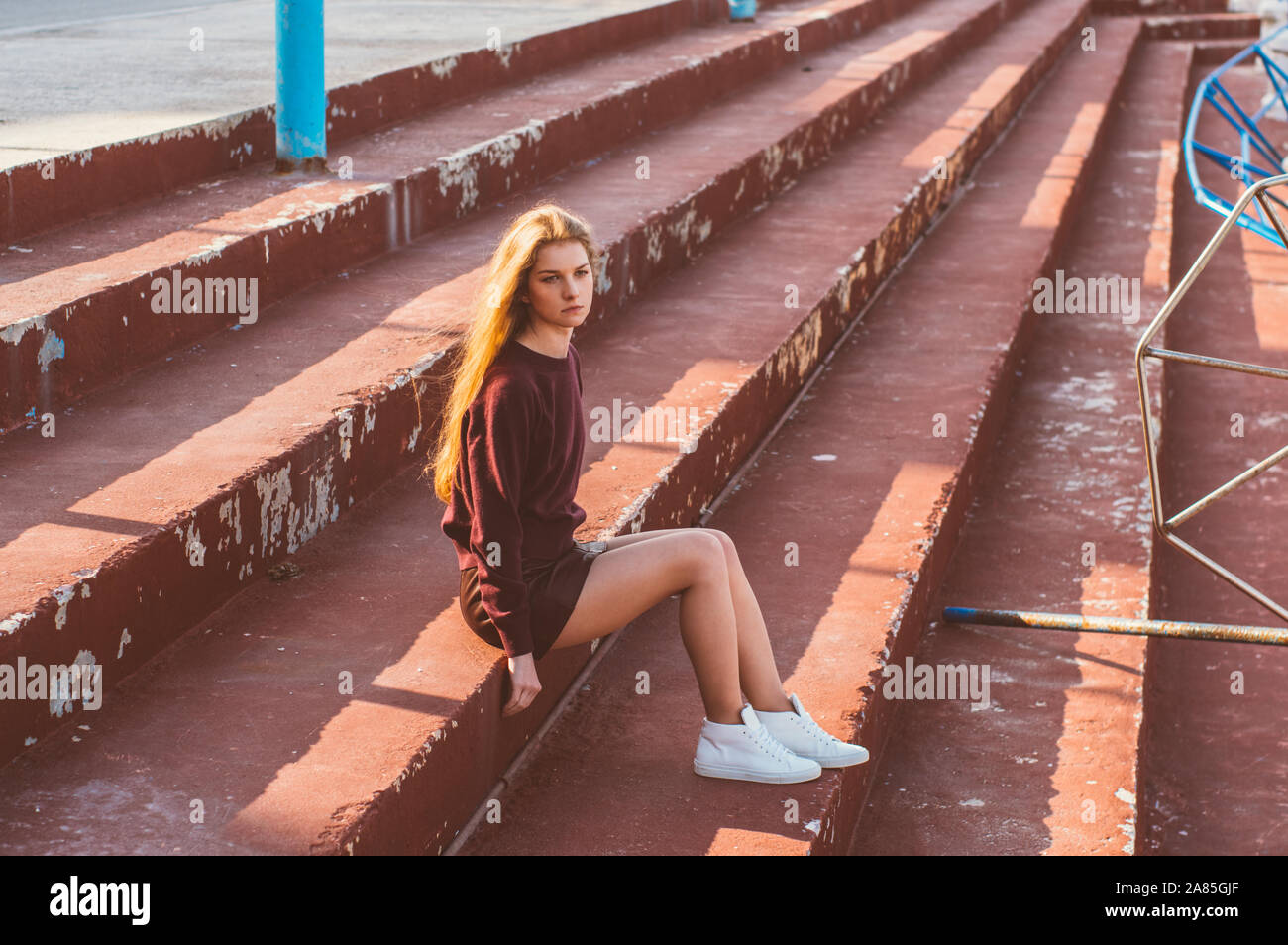 Woman sitting on stairs skirt hi-res stock photography and images - Alamy