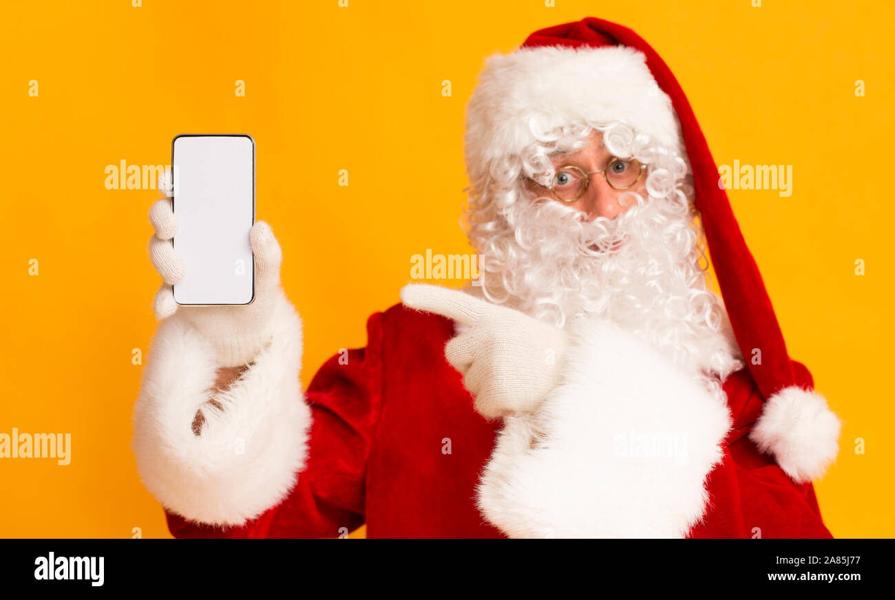Santa advertising new model of modern cellphone Stock Photo - Alamy