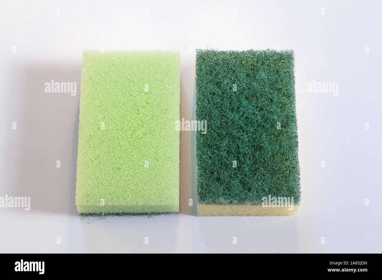 two kitchen sponges on white background.one sponge side one roughside ...